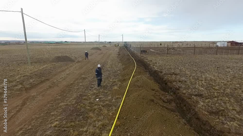 Heavy machinery making a trench for the placement of a gas pipeline ...