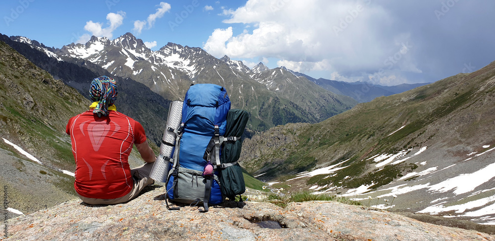 Back view of a backpacker walking alone in the Kaçkar Mountains. The ...