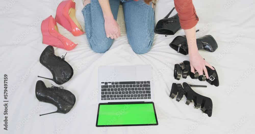 Shoe designer to learn. Woman comparing shoes in front of laptop screen ...