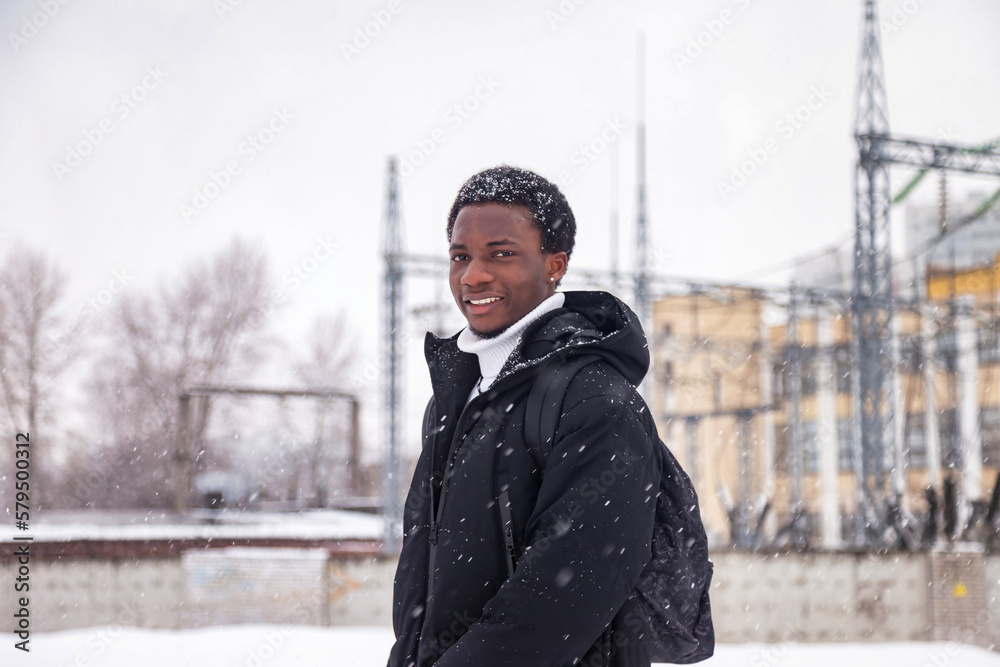 Portrait african american man posing in snowy russian winter at ...
