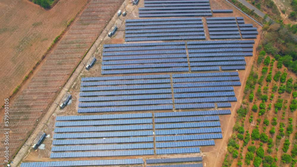 A vast array of solar panels spread across the landscape, glistening in ...