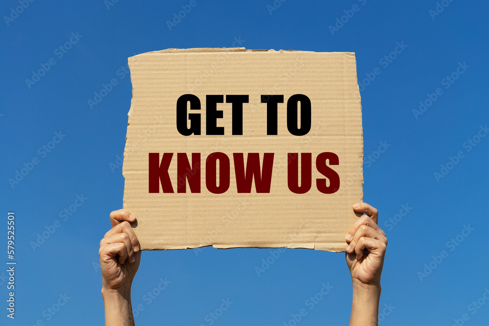 Get to know us text on box paper held by 2 hands with isolated blue sky background. This message ...