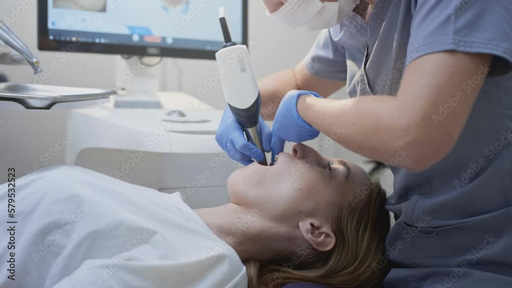 Orthodontist using 3D intraoral scanner for scanning teeth patient's ...
