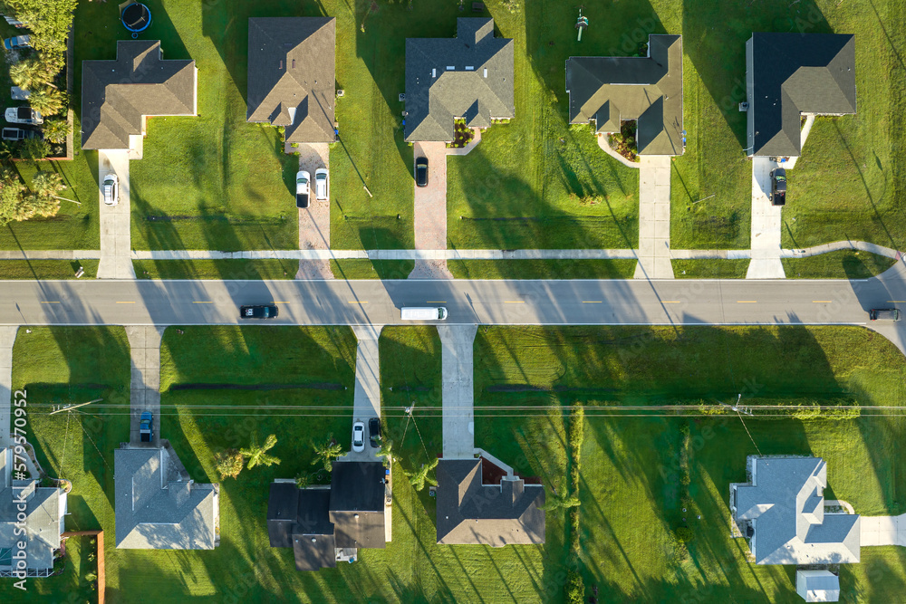 Aerial view of street traffic with driving cars in small town. American ...
