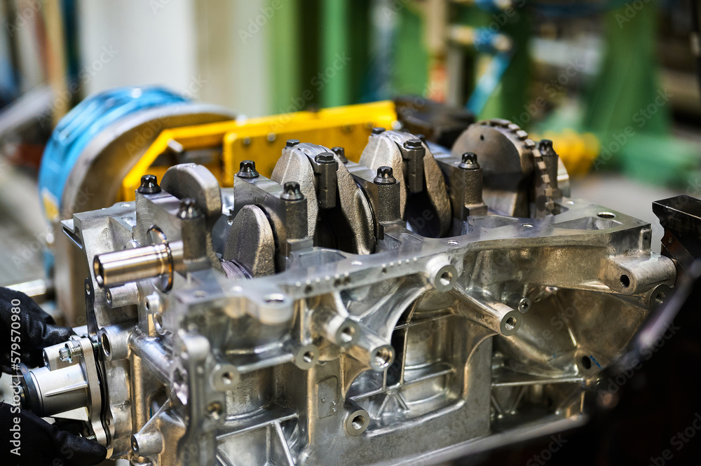 Cylinder block complete with crankshaft. Assembly line of internal ...