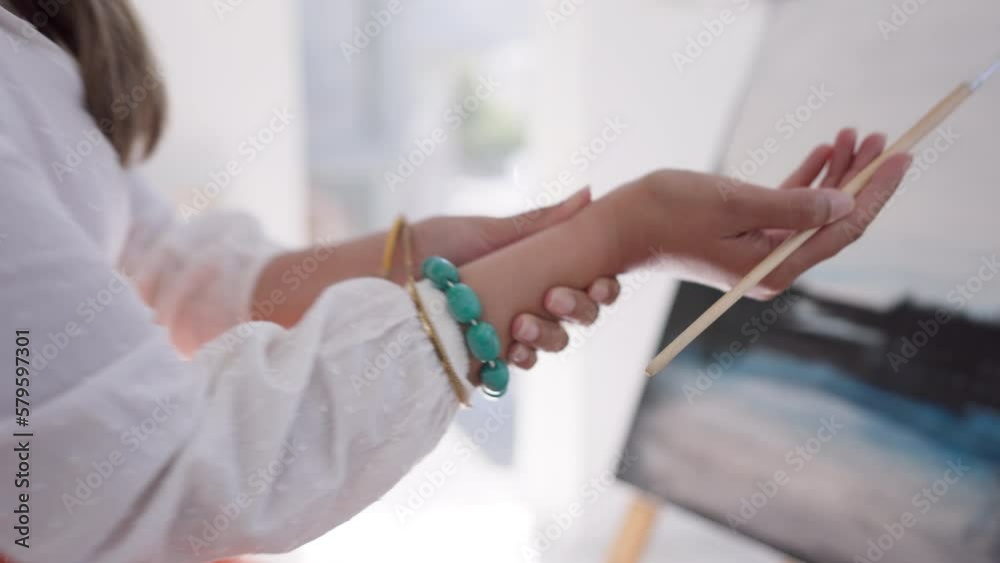 Wrist injury, painter and woman with creative painting on canvas in art ...