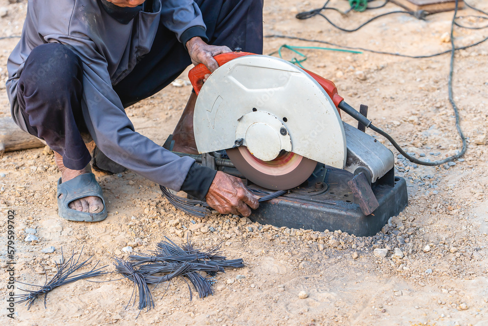 Man's hand using iron cutter in the workplace, fastening iron canopy ...