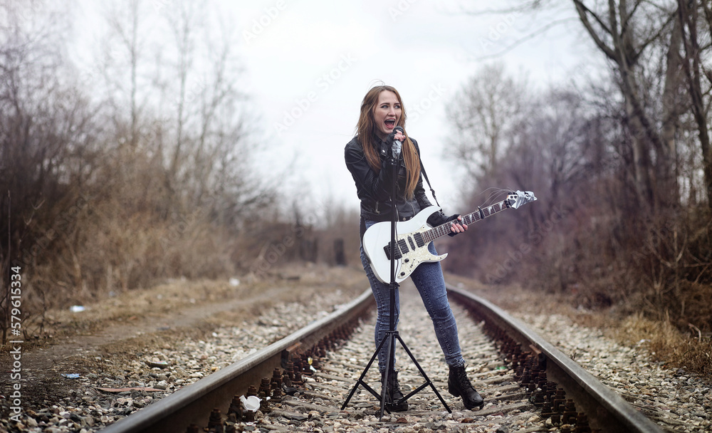 Beautiful young girl rocker with electric guitar. A rock musician girl ...