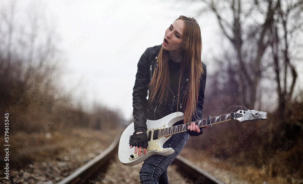 Beautiful young girl rocker with electric guitar. A rock musician girl ...
