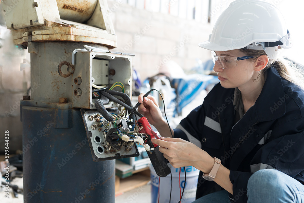 Female electrician worker checking, repair, maintenance operation ...
