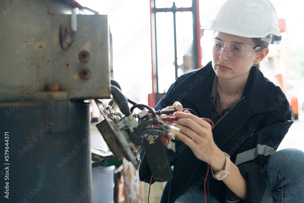 Female electrician worker checking, repair, maintenance operation ...