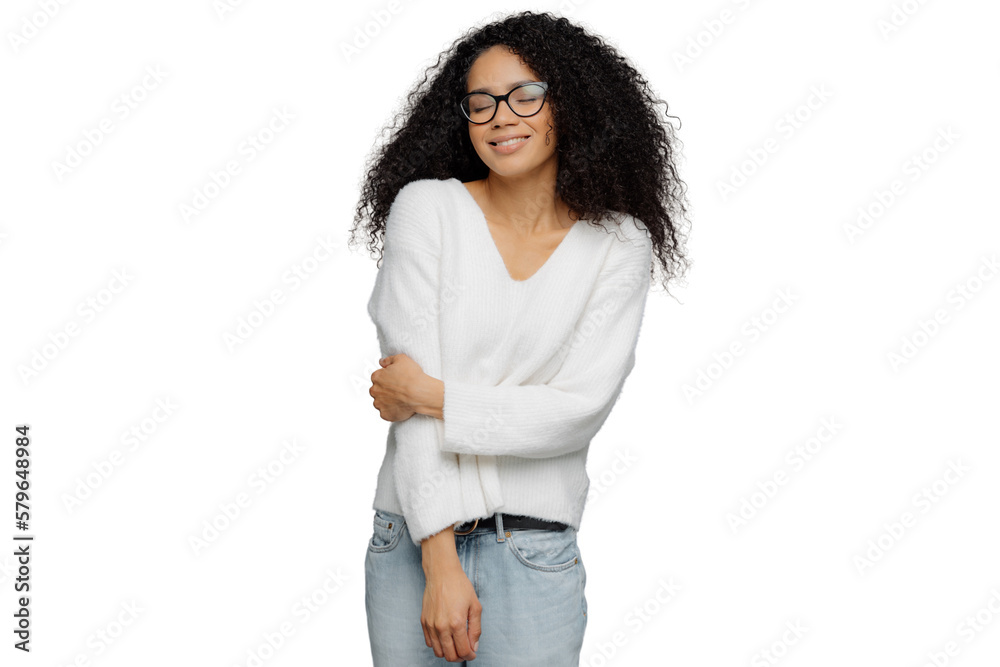 Foto Stock Indoor shot of sincere woman keeps hand partly crossed ...