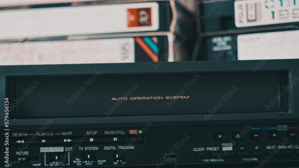 Insert VHS cassette into VCR player. Black vintage videotape cassette ...
