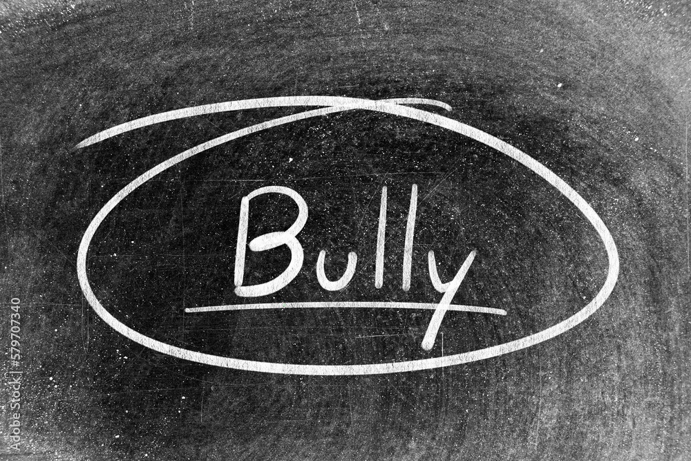 White chalk hand writing in word bully and circle shape on blackboard ...