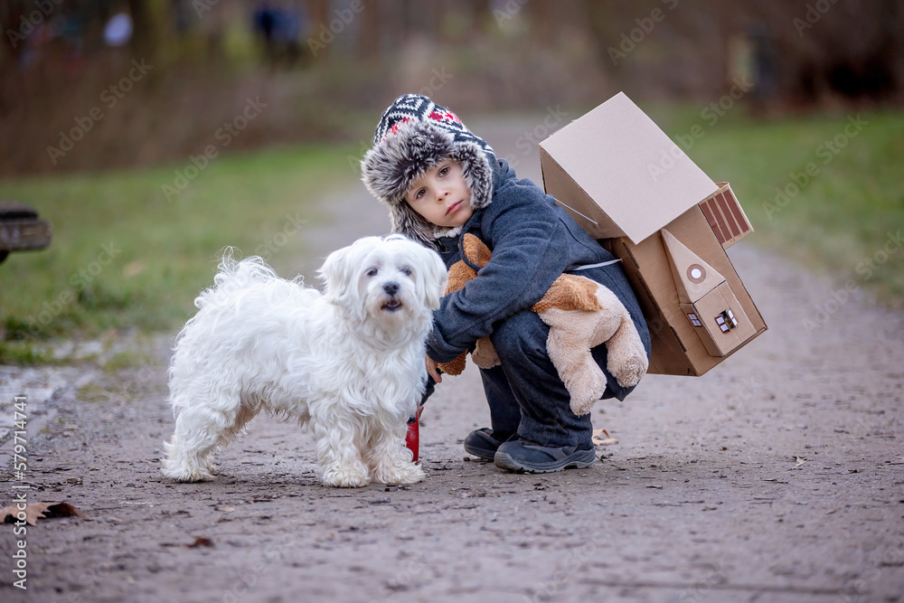 Little child, blond boy with pet dog, carying home on his back, kid ...