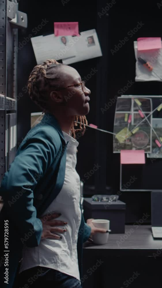 Vertical video: Law enforcement agent checking detective evidence map ...