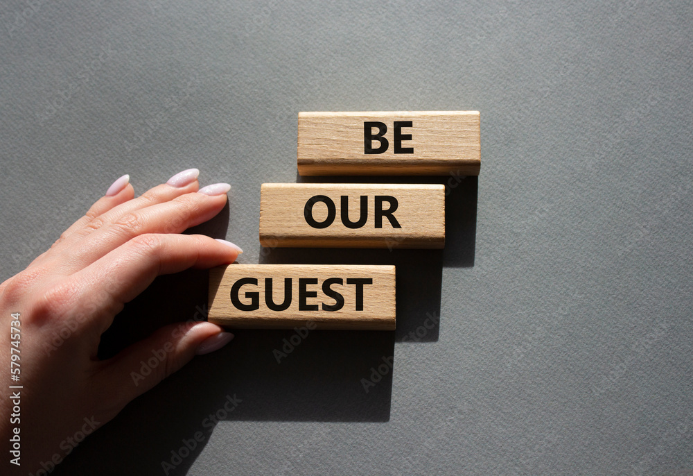 Be our guest symbol. Concept word Be our guest on wooden blocks ...