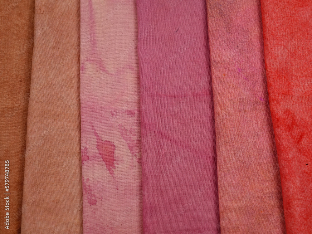 Samples of cotton fabric in light- dark red gradient, background ...