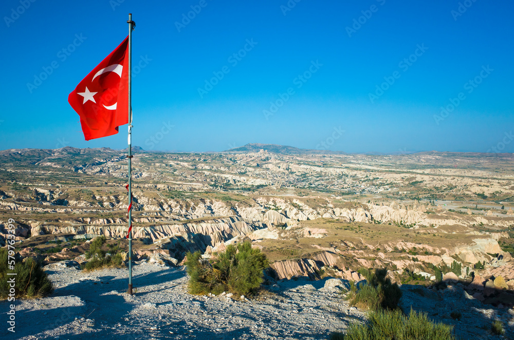 Turkish flag flutters in the wind over Cappadocia, view of the Central ...