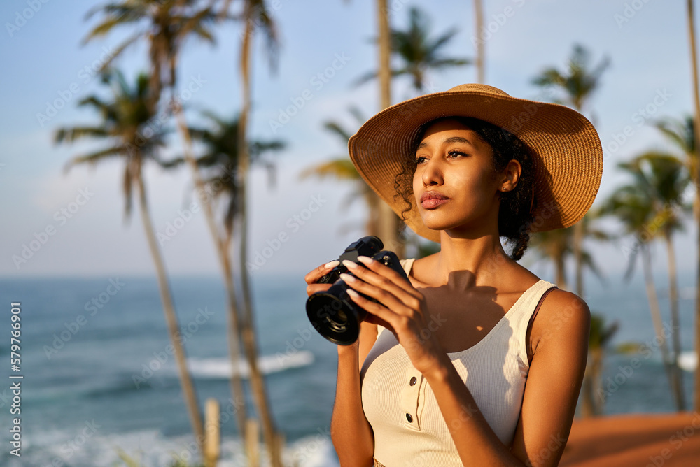 Young african female model tourist with camera in colorful clothes and ...