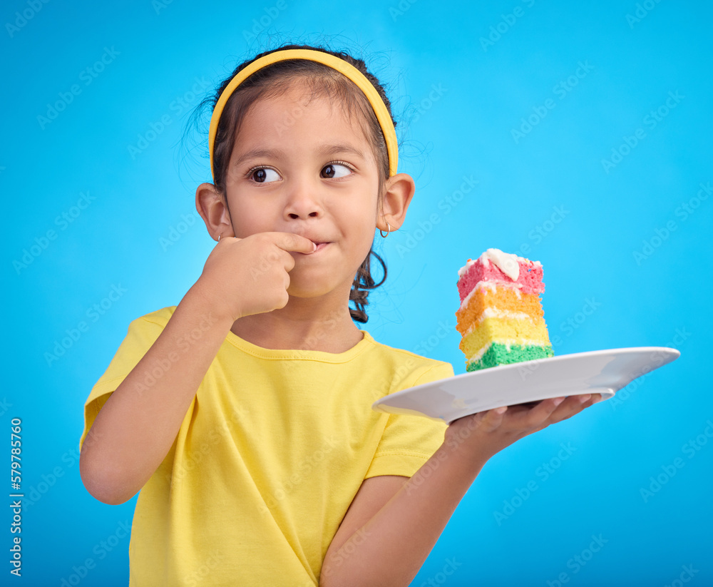 Birthday cake, taste and young girl with a sweet in studio eating icing ...