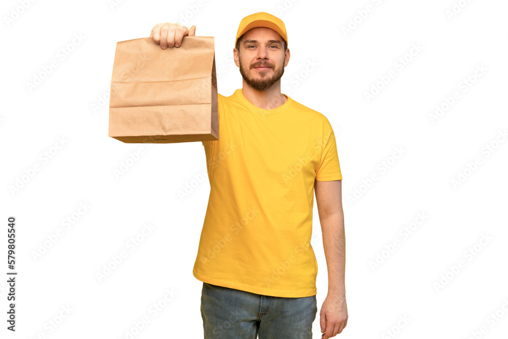Portrait of delivery man in yellow uniform with paper packet isolated ...
