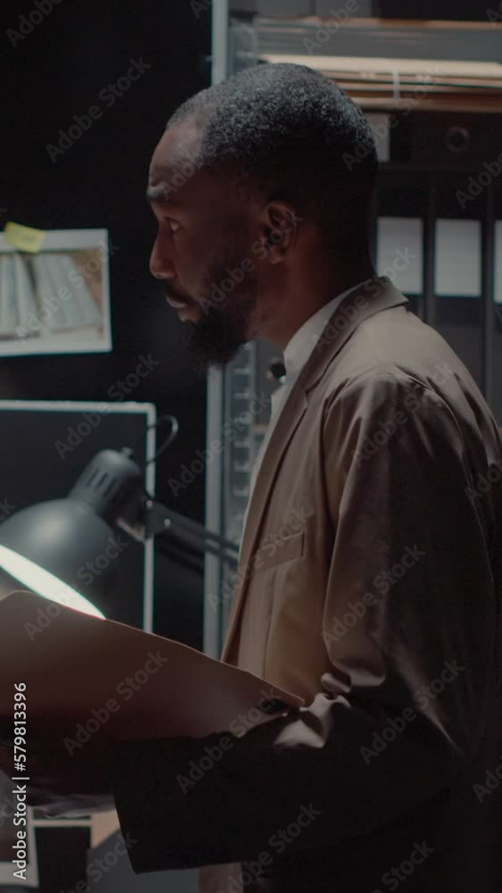 Vertical video: Detectives colleagues examining criminal files in ...