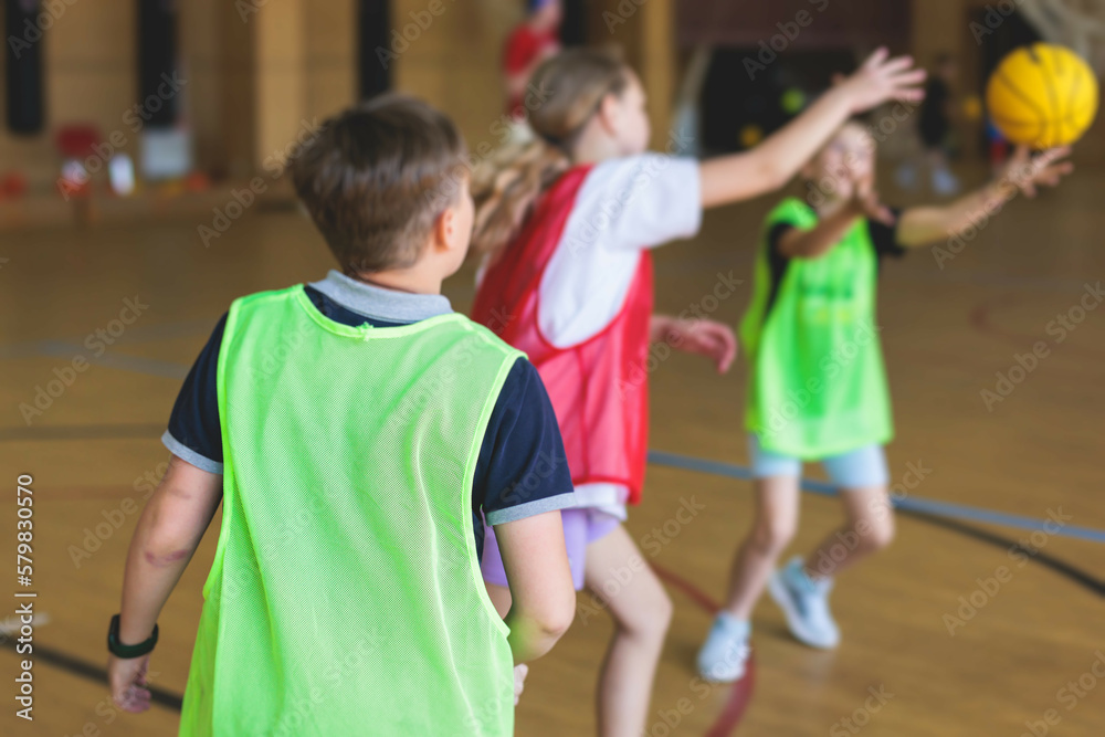 Junior teenage school team of kids children play basketball, players in ...