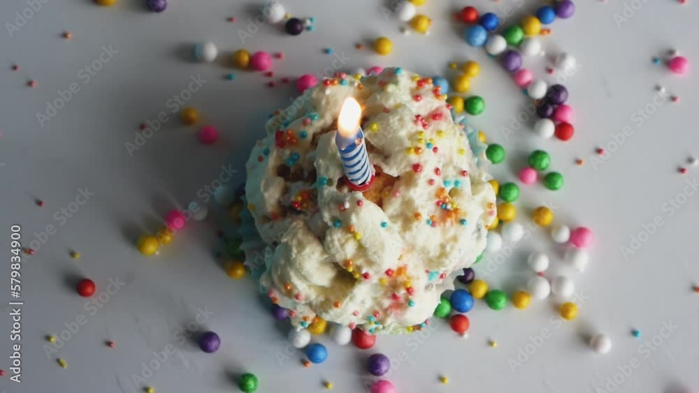 Birthday cake, Top view muffins with candles on the turntable, confetti ...
