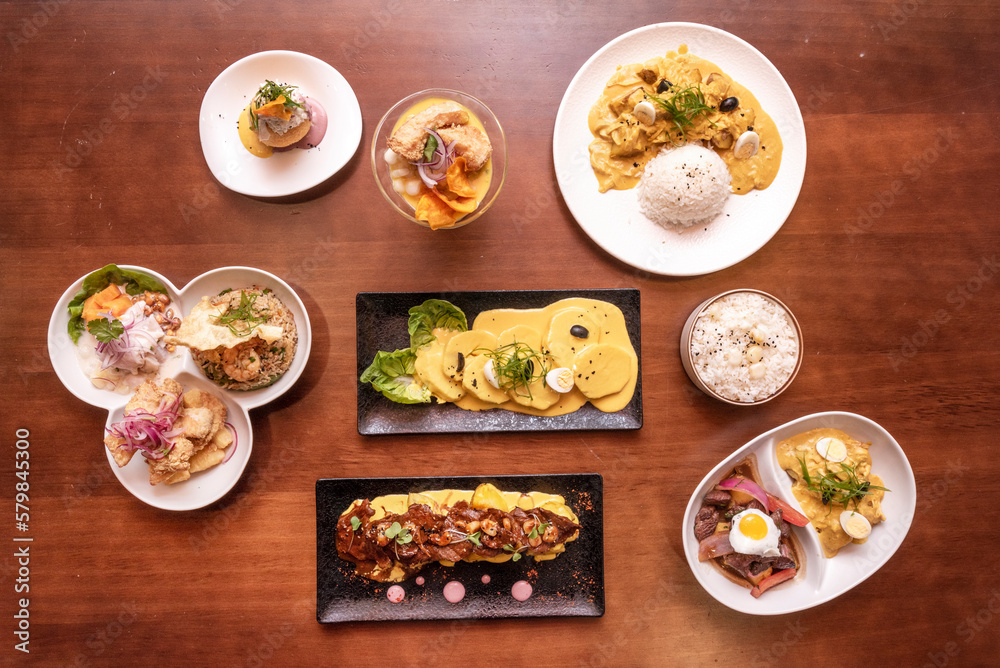 Still life with Peruvian food dishes with huancaina potatoes, ceviches ...