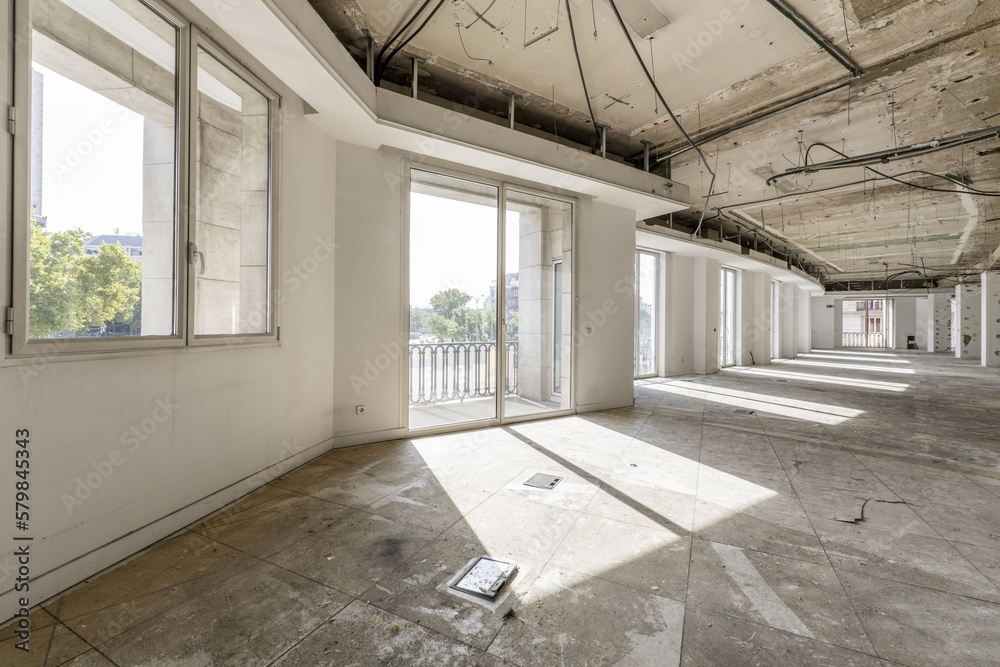 An office space under construction with many windows with balconies in ...