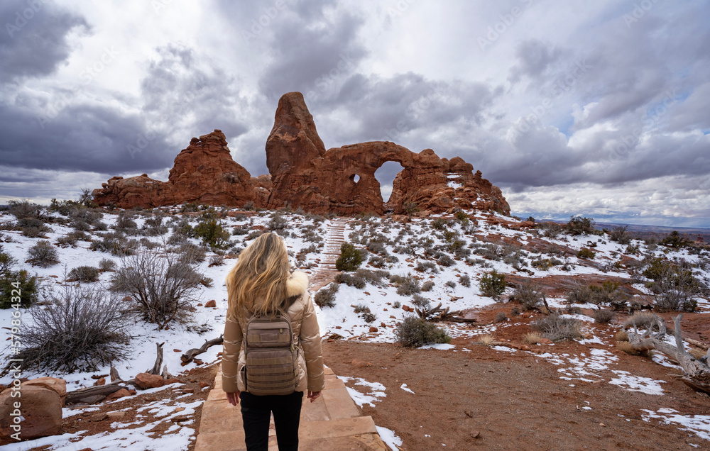Girl hiking in the red mountains. Woman hiking to Turret Arch on the ...