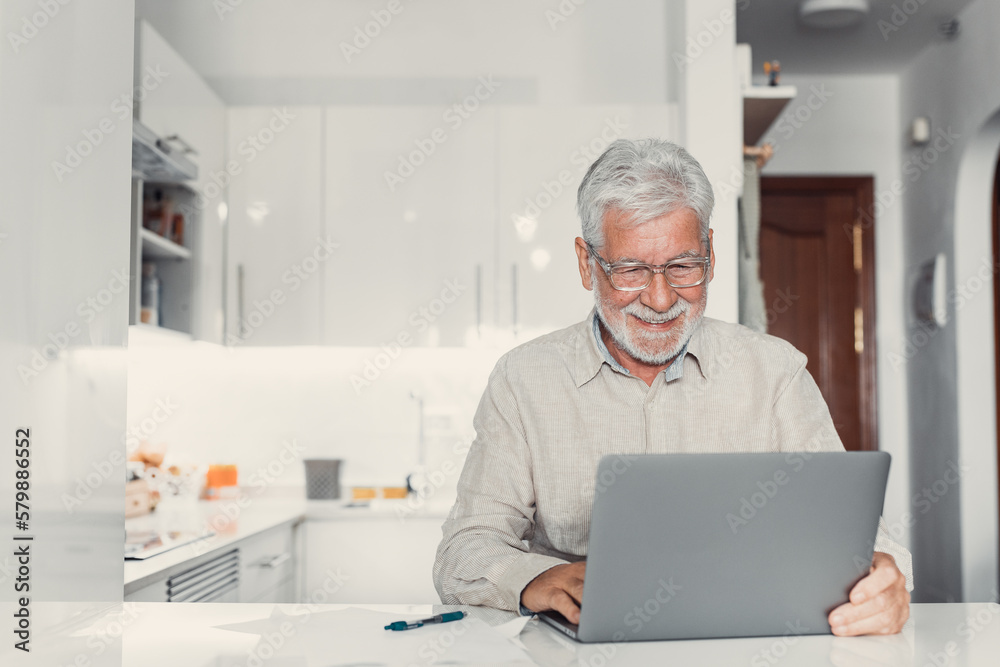 Aged remote worker. Concentrated senior male in glasses work on laptop ...