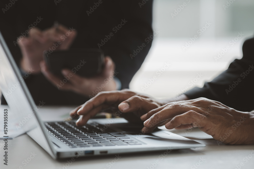 Person typing on laptop keyboard, businessman working on laptop, he is ...