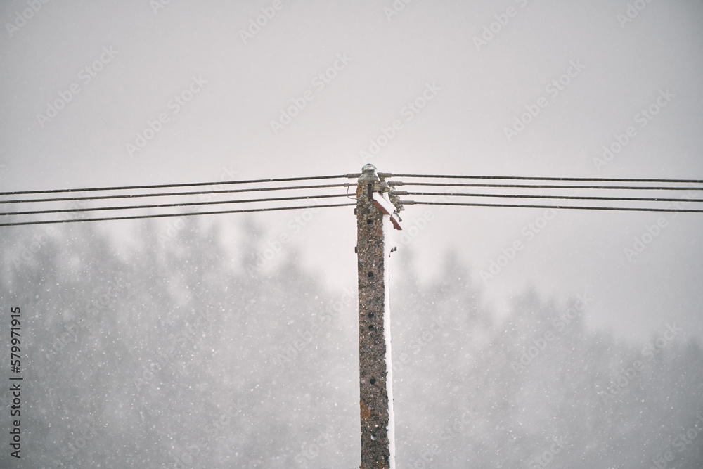 Heavy snow on electrical wires. Frozen electric wires in the city ...