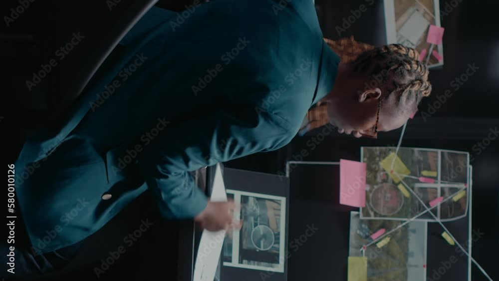 Vertical video: Police investigator examining clues from crime scene ...