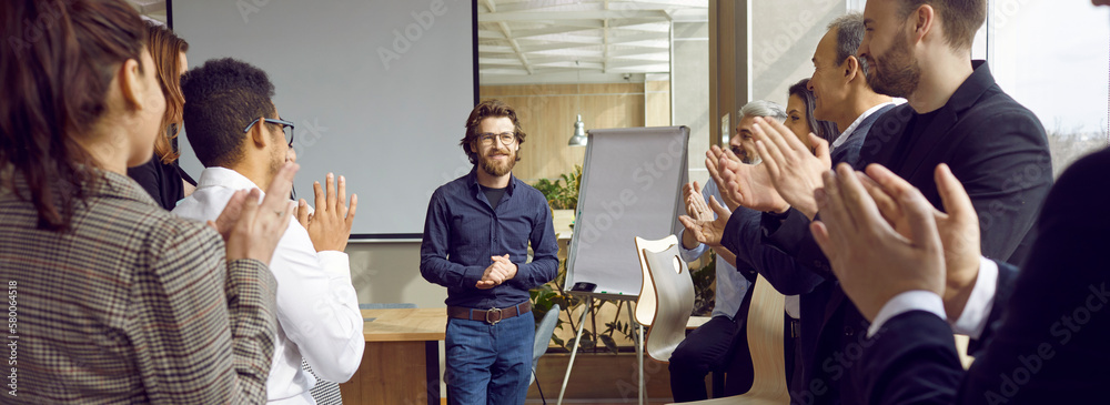 Group of people are greeting man coach standing near flipboard in ...