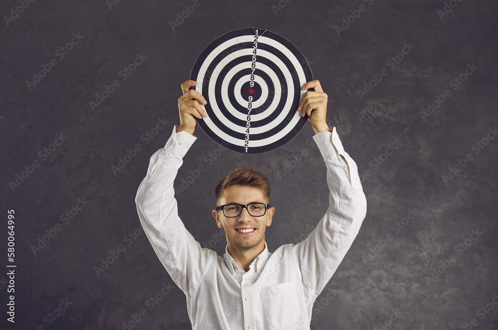 Portrait of happy man holding shooting target. Studio shot of smiling ...