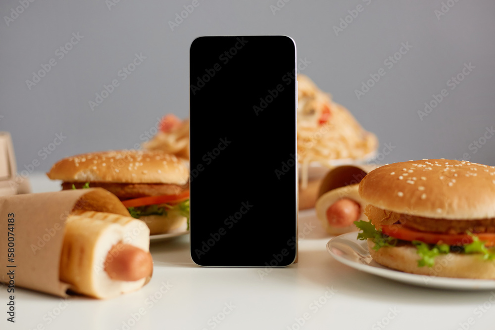 Image of table with different fast food and smart phone with balck ...