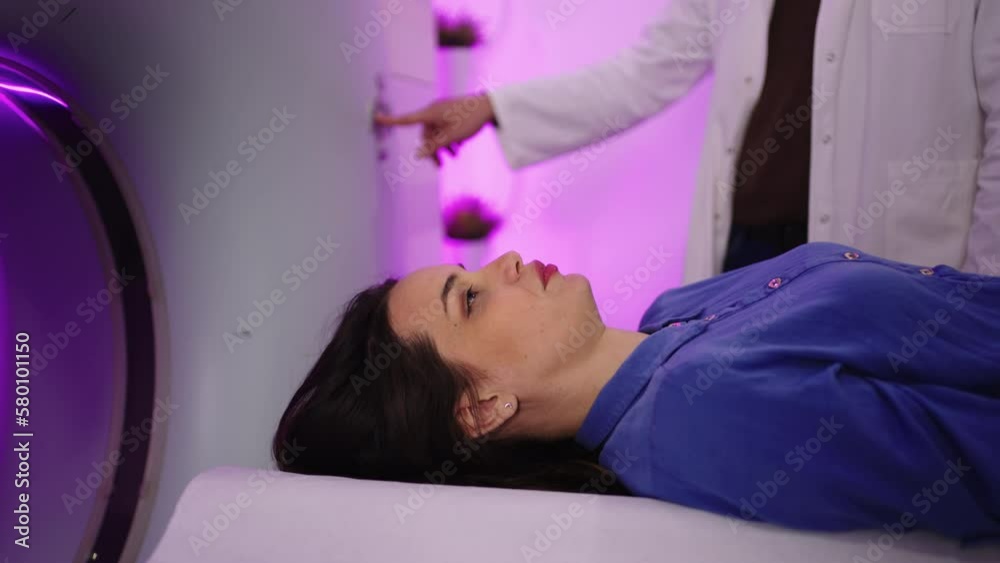 Close-up shot of a patient in MRI machine for a CT scan. Female patient ...