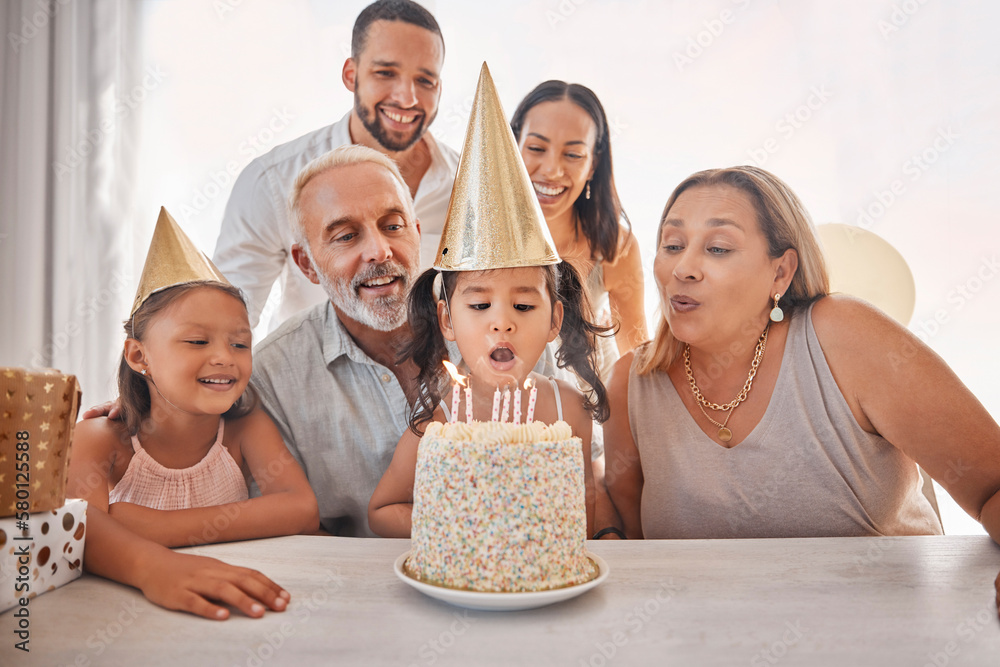 Girl, birthday cake and candles for happy family at party, celebrate or together in home. Child ...