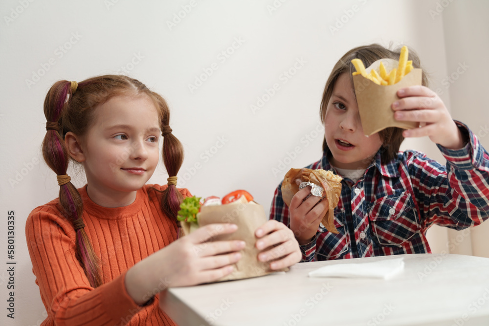 White kids eating traditional Greek food - souvlaki with grilled beef ...