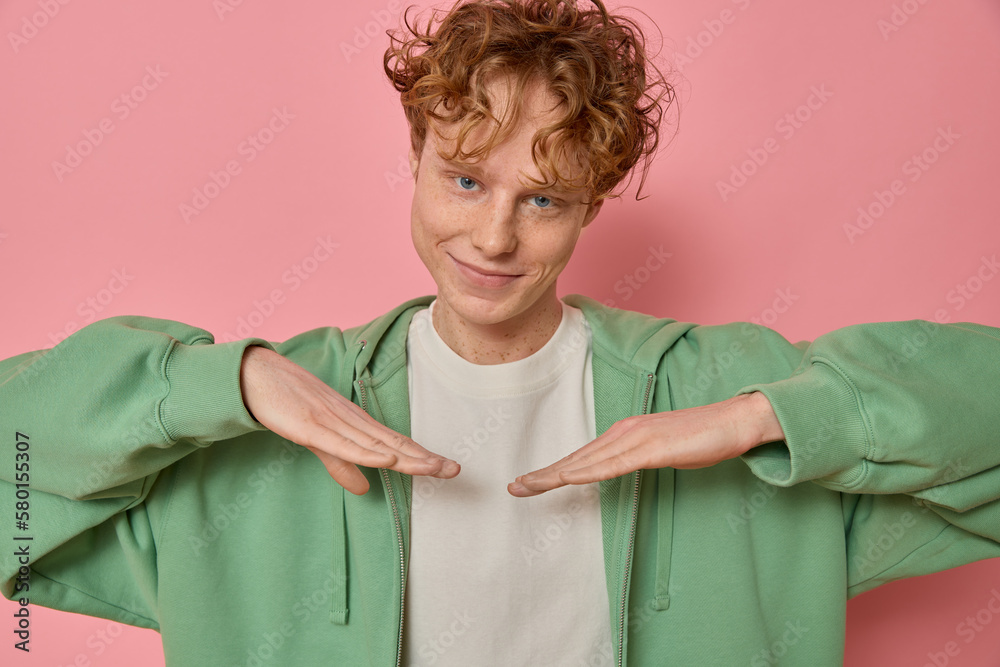 Studio portrait of a redhead male with freckles in colourful clothing ...
