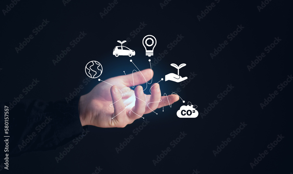 Hand holding virtual Global with CO2 reducing icon for concept of decrease carbon dioxide ...