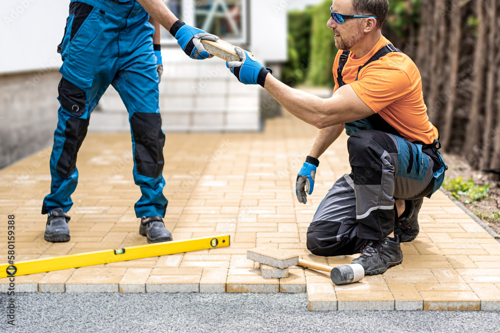 Laying of interlocking paving stones. Stock Photo | Adobe Stock