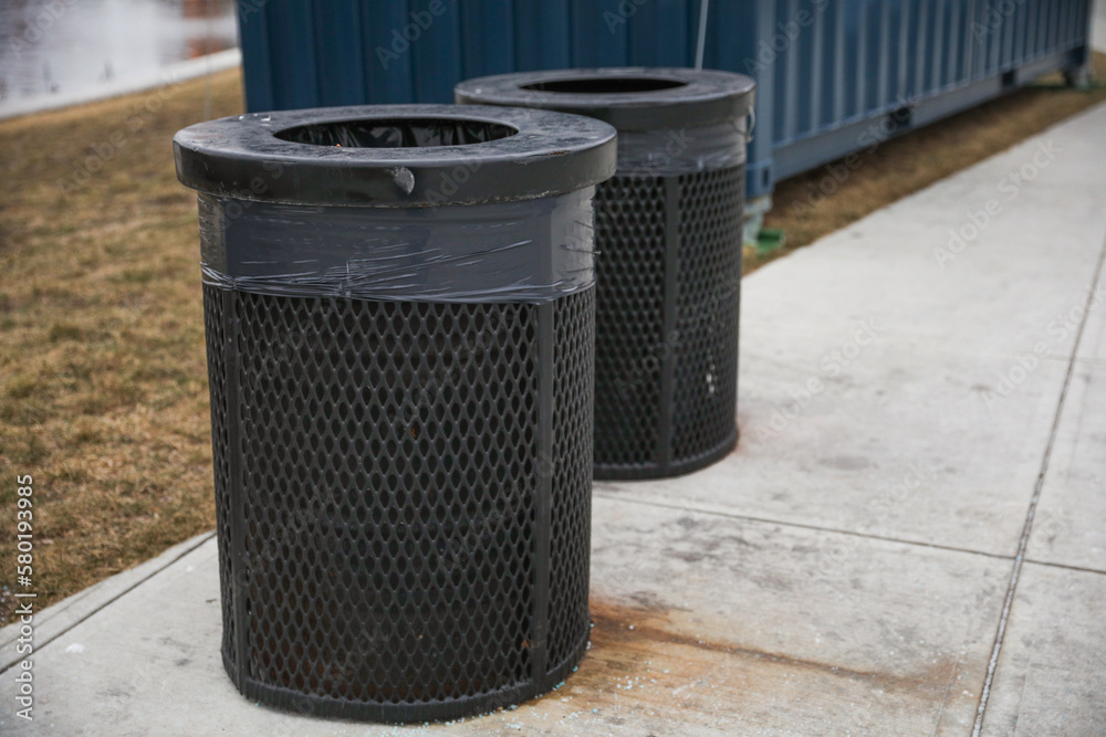 Trashcan and garbage bin outdoor in the street symbolizing ...