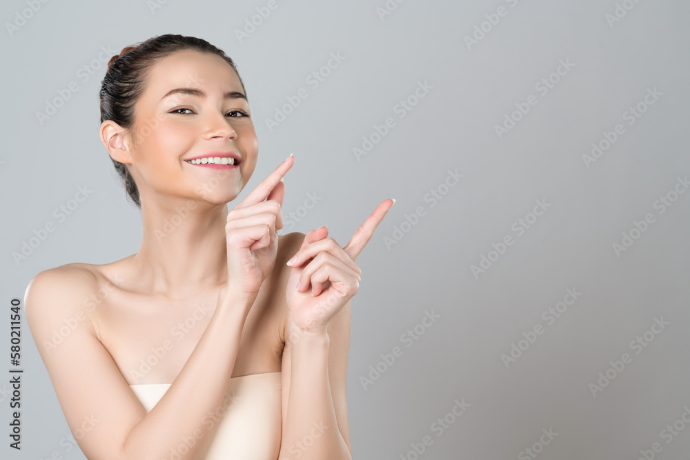 Glamorous beautiful woman with perfect makeup clean skin pointing ...