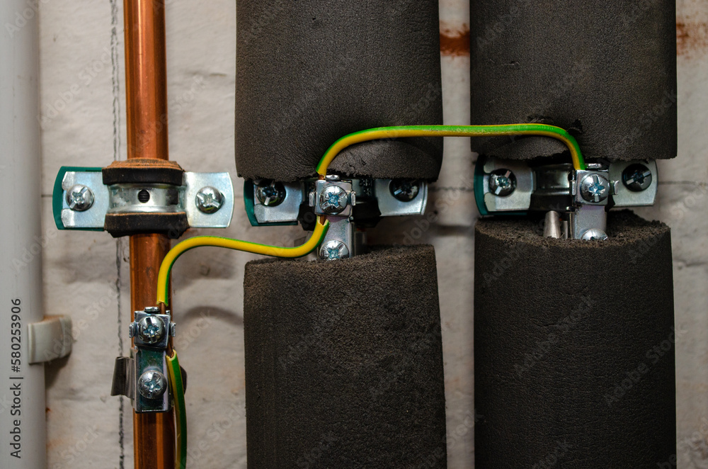 Connecting the ground wire to the copper pipe Stock Photo | Adobe Stock