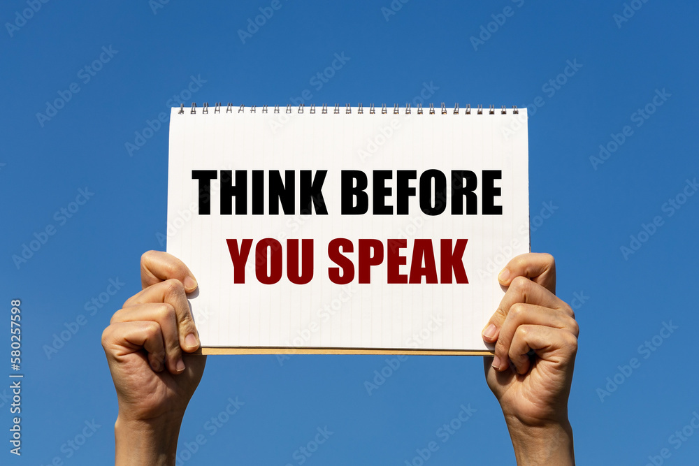 Think before you speak text on notebook paper held by 2 hands with ...