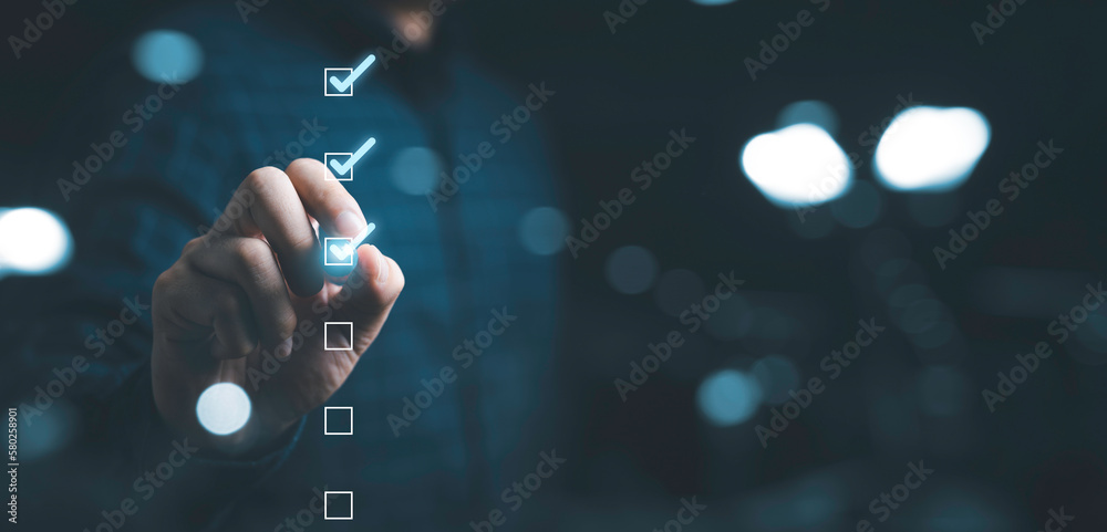 Business use electronic pen to tick check mark for quality assurance ...